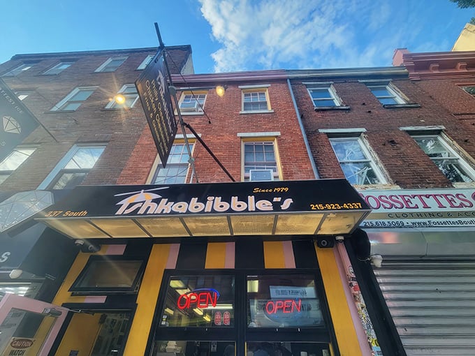 With its playful stripes and glowing neon, Ishkabibble’s bright South Street facade has been luring cheesesteak lovers in since 1979.
