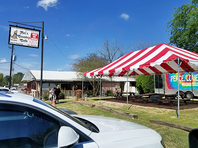 The unassuming exterior of Mel's Country Cafe proves once again that the best Texas treasures don't need fancy facades—just that red and white awning signaling "good food ahead."