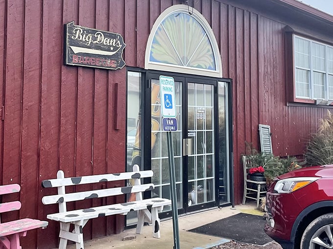 The red barn-like exterior of Big Dan's isn't just charming—it's a beacon of hope for hungry travelers. Those white benches? They're not decoration; they're for the inevitable wait.