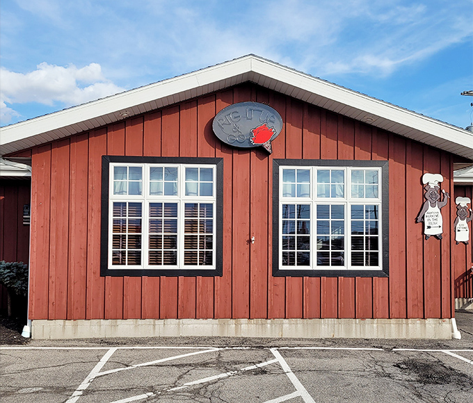 The unassuming exterior of Red Pig Inn proves once again that the best barbecue joints don't need fancy facades—just a welcoming bench and the promise of smoky delights within.