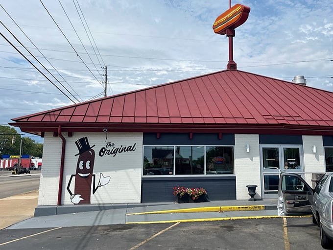 That iconic hot dog sign atop the red roof isn't just decoration—it's a beacon of hope for hungry travelers seeking frankfurter nirvana in Warren.