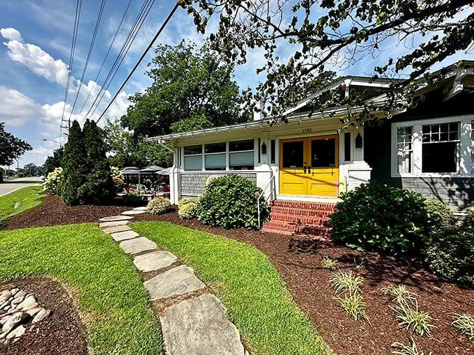Those cheerful yellow doors aren't just an entrance – they're a promise of the breakfast bliss waiting inside this charming Virginia Beach cottage.