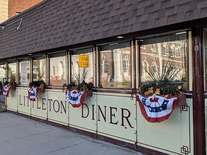 The Littleton Diner's mint-green exterior with patriotic bunting isn't trying to impress anyone—it's too busy perfecting what's inside. Classic New Hampshire charm at its finest.