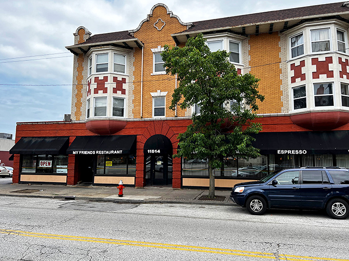 The distinctive orange-brick façade of My Friend's Restaurant stands as a Cleveland landmark, promising comfort beneath those classic red awnings.