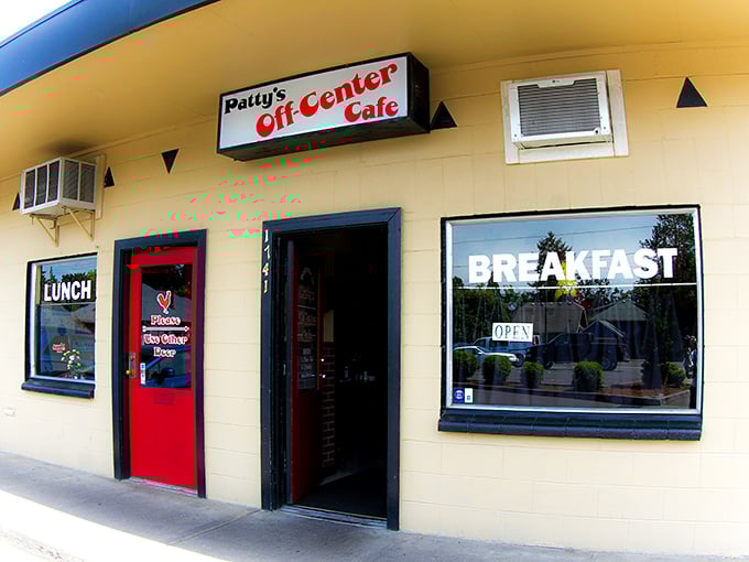 The unassuming yellow exterior with that bright red door is like a secret handshake – only the worthy know what culinary treasures await inside.