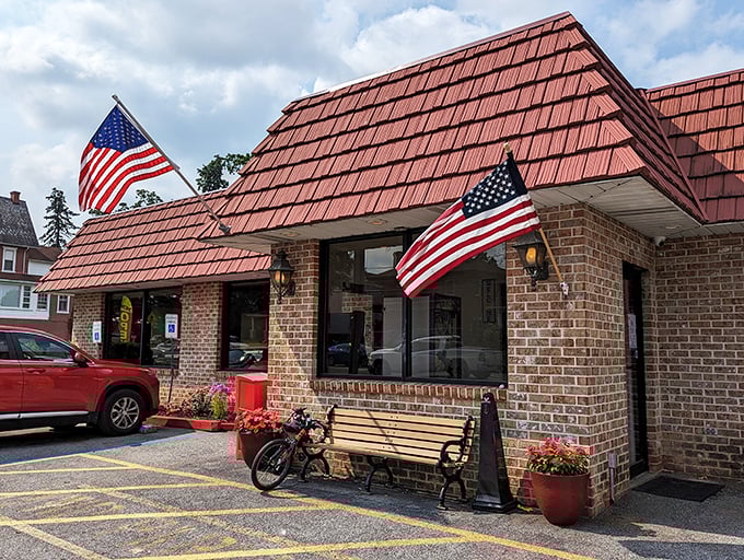 The iconic red-shingled roof and American flags announce you've arrived at breakfast paradise. Small-town charm with big-time flavor awaits.