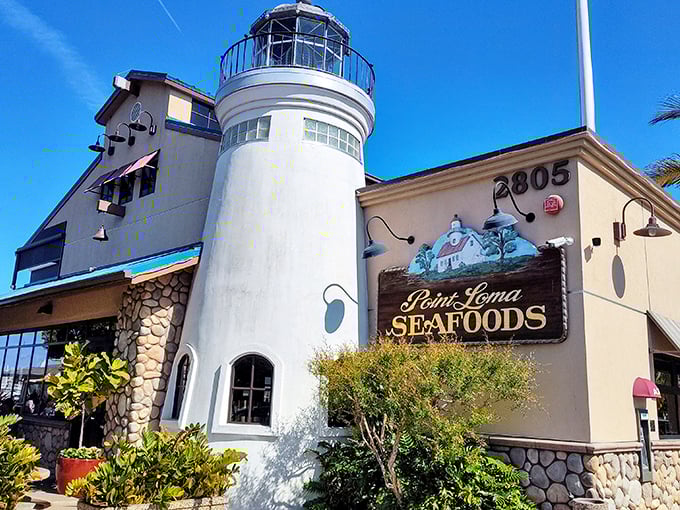 The lighthouse-shaped entrance isn't just architectural whimsy—it's a beacon calling seafood lovers home to this San Diego institution.