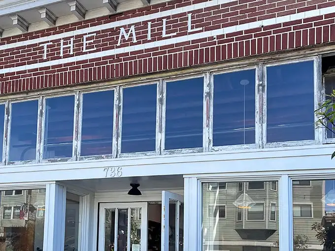 The Mill's iconic brick facade stands like a temple to toast on Divisadero Street, promising carb-laden revelations within those weathered windows.