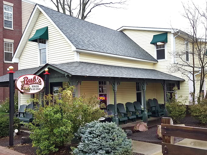The charming yellow house with green awnings isn't just another pretty facade—it's burger paradise hiding in plain sight in Carmel.