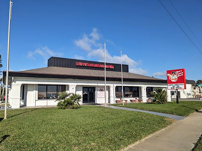 Steve's Famous Diner stands proudly against the Florida sky, its red sign promising "Happy Food, Good Vibes" – a roadside beacon for hungry travelers.