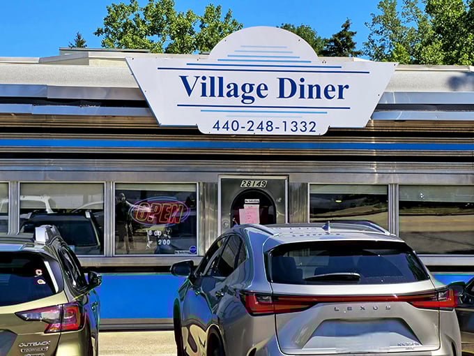 The classic silver exterior of Village Diner gleams in the sunshine, a time capsule of Americana promising comfort food that hugs your soul.