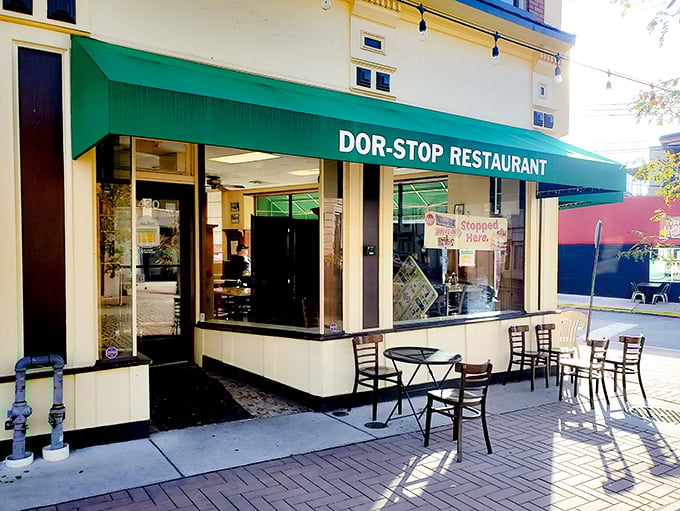 The iconic green awning of Dor-Stop Restaurant beckons breakfast enthusiasts like a lighthouse guiding hungry sailors to shore.