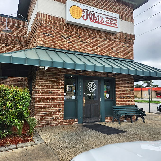 The brick fortress of flavor that houses Kiki's Chicken and Waffles stands unassumingly on Parklane Road, its green awning beckoning hungry travelers like a culinary lighthouse.