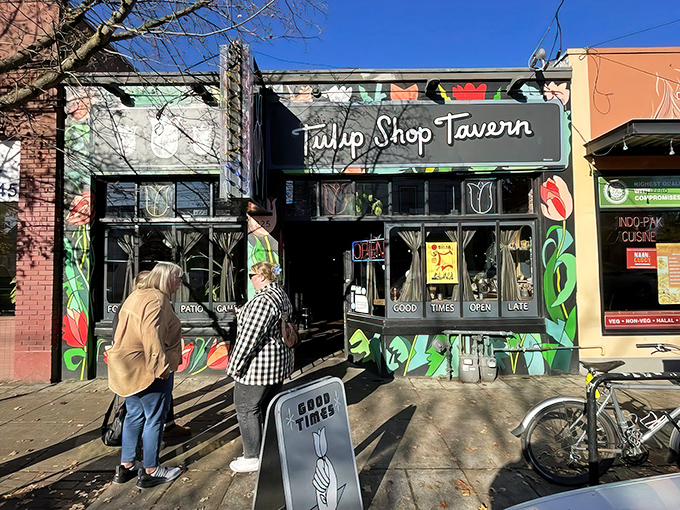 The vibrant tulip murals adorning Tulip Shop Tavern's exterior aren't just pretty decoration—they're a promise of the colorful flavors waiting inside this North Portland gem.