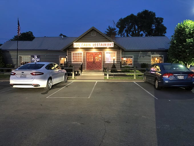 The iconic gray exterior with that unmistakable red door beckons hungry travelers like a lighthouse for comfort food enthusiasts.