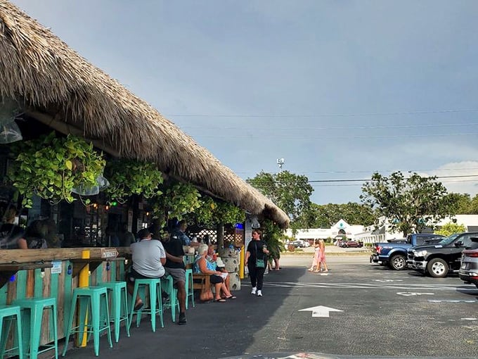 The thatched tiki bar at Walt's beckons like a tropical mirage in a parking lot—Florida's version of finding an oasis in the desert.