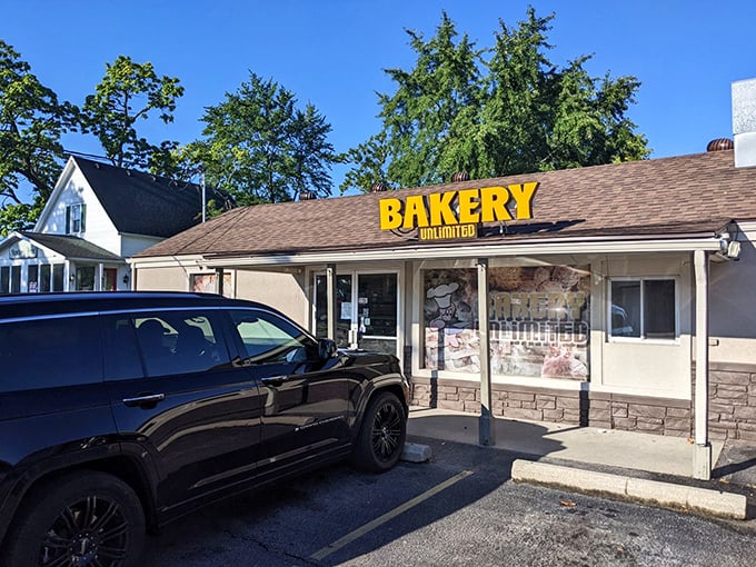 That bright yellow "BAKERY UNLIMITED" sign isn't just advertising – it's practically a beacon of hope for donut lovers everywhere.