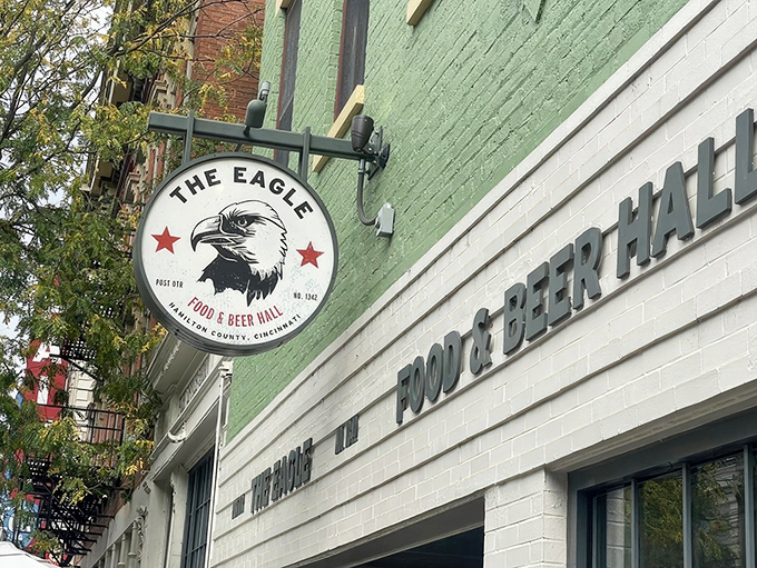 The mint-green facade of The Eagle OTR stands out like a culinary beacon on Vine Street, promising Southern comfort with urban flair.
