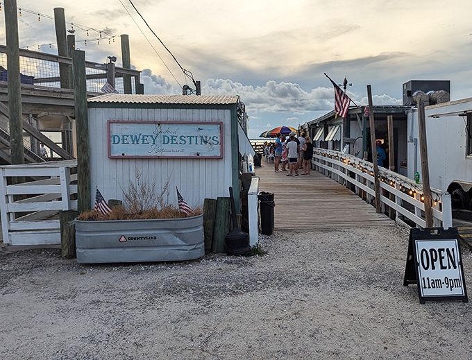 The entrance to paradise isn't pearly gates, but a weathered wooden boardwalk leading to Dewey Destin's—where seafood dreams come true and calories don't count.