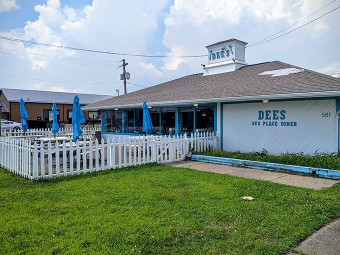 The classic white picket fence and blue umbrellas aren't just charming – they're a promise that inside this unassuming Barberton treasure, calorie counting is strictly prohibited.