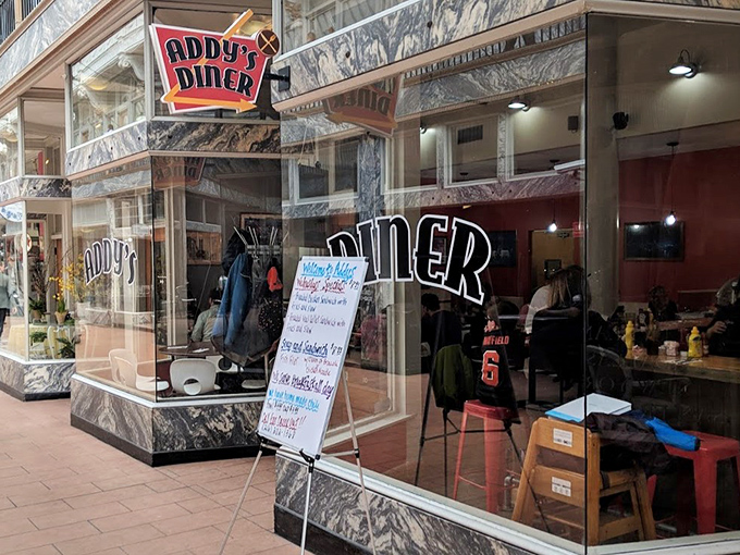 Addy's classic storefront beckons with marble accents and neon signage—like a time portal to when breakfast was an art form, not just a meal.