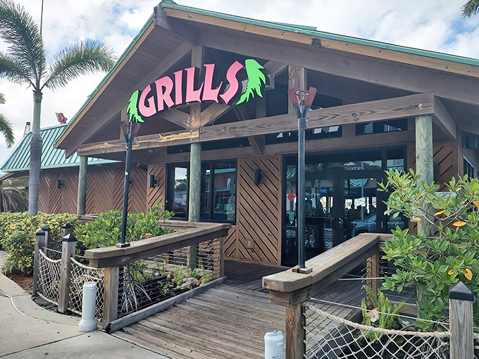 The neon-pink sign beckons like a tropical siren, promising seafood salvation just steps from the water. Florida architecture at its most honest—ready for hurricanes but optimistic about tomorrow. 