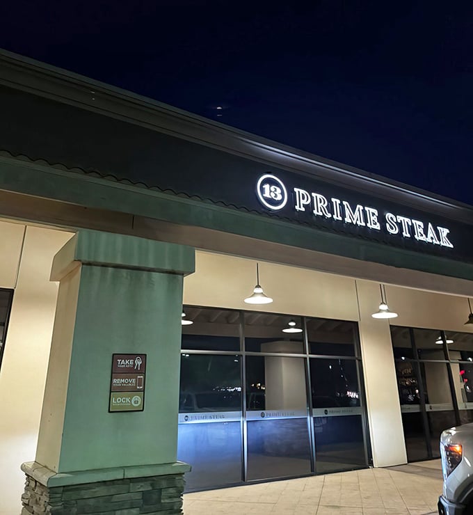 By night, the illuminated sign beckons meat lovers like a carnivorous lighthouse guiding hungry sailors to beefy shores.