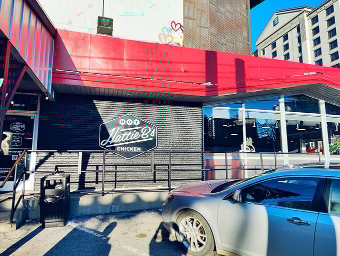 That iconic red awning isn't just a design choice—it's Nashville's equivalent of a lighthouse, guiding hungry souls to hot chicken paradise.