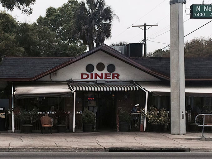 Three coins on the facade aren't just decoration—they're a promise of the culinary treasures waiting inside this unassuming Tampa landmark.