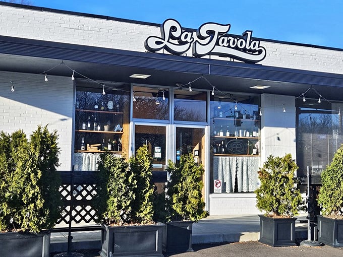 The unassuming white brick façade of La Tavola might not scream "culinary destination," but those evergreens are practically waving you in for pasta perfection.
