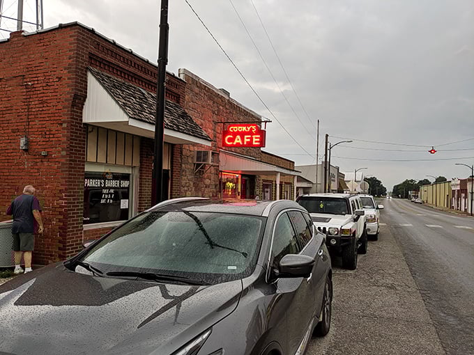 Main Street Americana at its finest—Cooky's red neon sign glows with promise, beckoning hungry travelers to pull over and discover what locals already know.