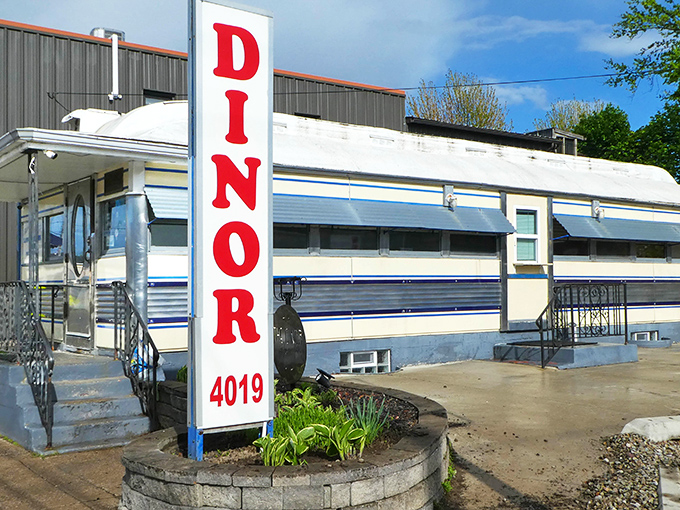 The iconic blue-striped railroad car with its bold red "DINOR" sign stands as Erie's time capsule of comfort food glory.