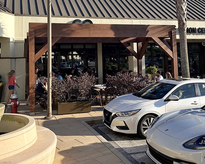 CO's welcoming outdoor seating area invites passersby to pause their shopping for a Southeast Asian flavor adventure beneath South Carolina's swaying palms.