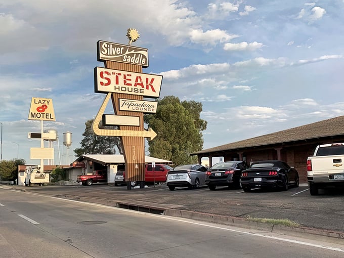 That vintage sign isn't just advertising – it's a beacon of hope for the hungry. Mesquite-broiled promises under the Arizona sky.