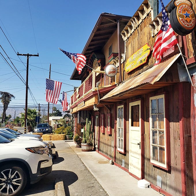 The wooden façade of Mill Creek Cattle Company looks like it was plucked straight from a John Wayne movie set, complete with hay bales and American flags.