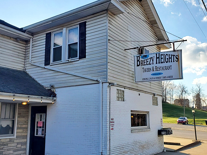The unassuming exterior of Breezy Heights Tavern proves once again that culinary treasures often hide behind the simplest facades. Established in 1927!