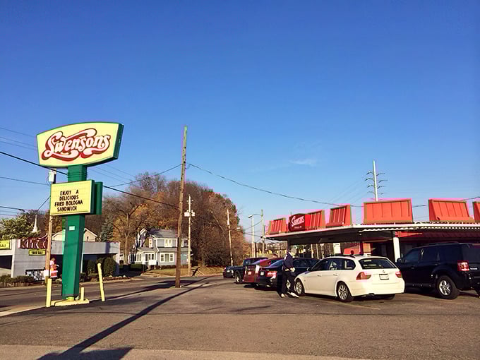The iconic red roof of Swensons beckons like a beacon of burger bliss, promising a taste of Americana that's survived the fast-food revolution unscathed.