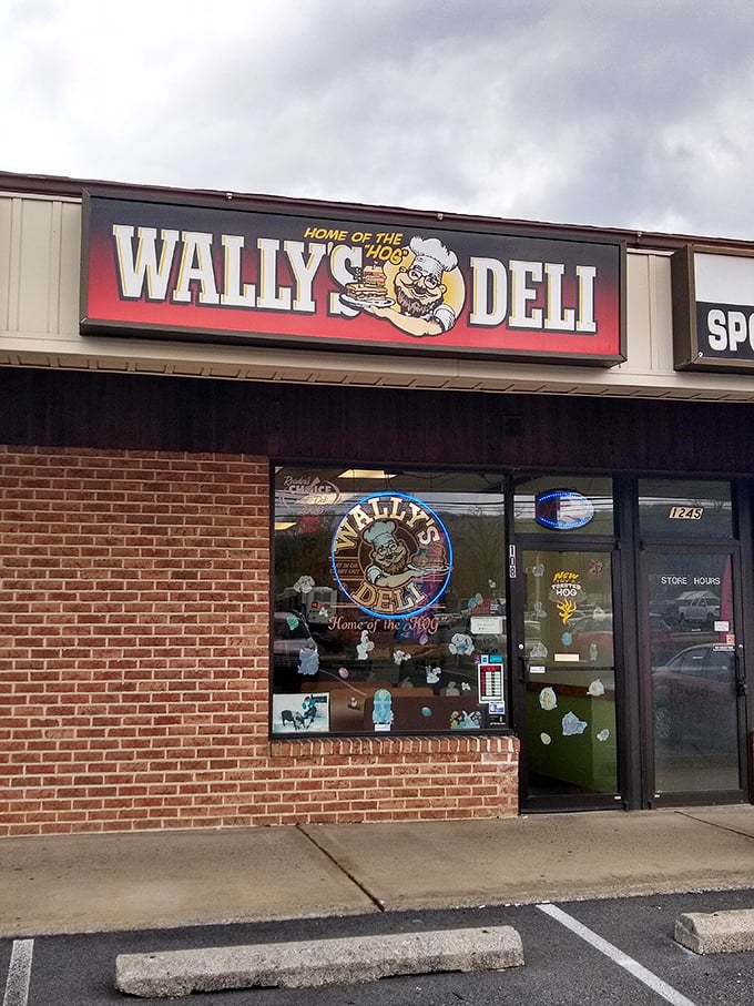 The unassuming storefront of Wally's Deli proudly declares itself "Home of the HOG" – a promise that sandwich lovers know is gloriously fulfilled inside.