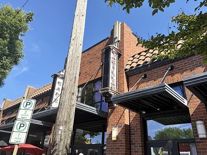 The brick façade of Cadillac Café stands as Portland's breakfast beacon, promising culinary delights behind its unassuming exterior.