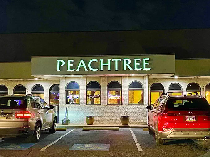 The glowing Peachtree sign beckons like a lighthouse for hungry souls. Even at night, this unassuming strip mall gem promises culinary treasures within.