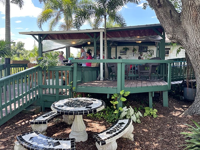 Outdoor dining at its most Floridian—palm trees, sunshine, and a deck where conversations flow as freely as the sweet tea.