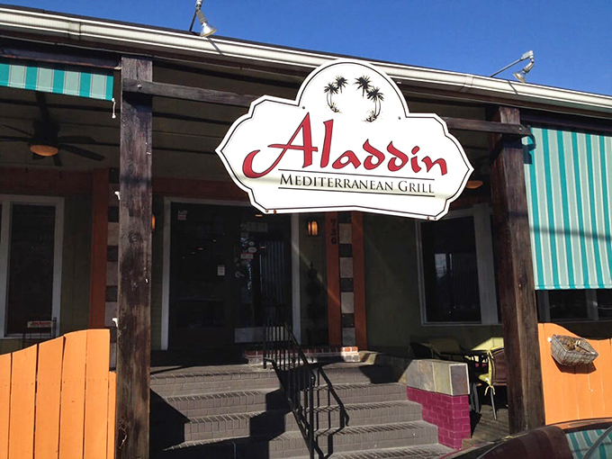 The teal-striped awnings and vibrant orange accents of Aladdin's exterior aren't just eye-catching—they're practically sending smoke signals to hungry passersby: "Mediterranean magic happens here!"