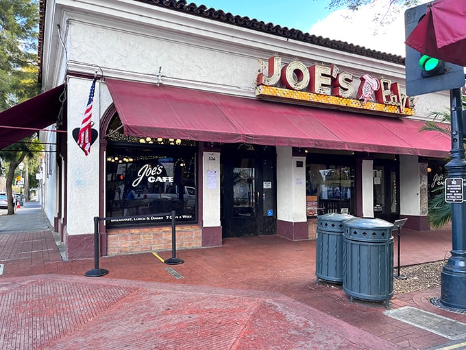 The iconic red awning of Joe's Café beckons hungry travelers like a culinary lighthouse on Santa Barbara's State Street.