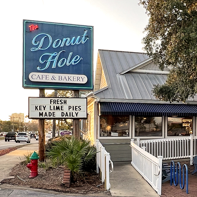 The iconic blue-trimmed exterior of Donut Hole beckons like a siren song to hungry travelers. That white picket fence isn't just charming—it's crowd control for the breakfast rush!