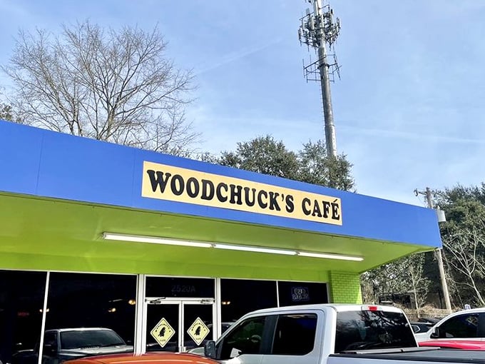 The blue and lime green exterior of Woodchuck's Café stands out like a cheerful beacon for hungry travelers. No fancy frills, just the promise of good eating ahead.
