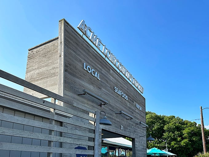 The weathered wooden facade isn't just rustic charm—it's a promise of authenticity. LOCAL. SEAFOOD. FRESH. Three words that sum up the Acme experience perfectly.