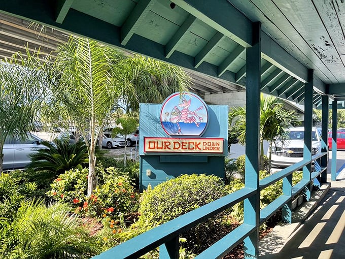 The turquoise welcome sign says it all – this isn't just seafood, it's an under-bridge adventure waiting to happen.