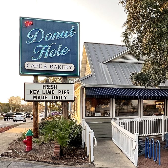 The iconic blue-trimmed exterior of Donut Hole beckons like a siren song to hungry travelers. That white picket fence isn't just charming—it's crowd control for the breakfast rush!