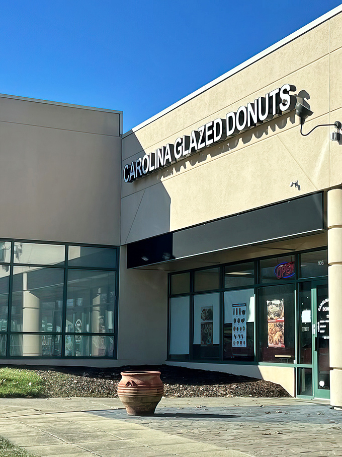 The unassuming storefront belies the magic within. Like finding a treasure map in your junk drawer, Carolina Glazed Donuts promises sweet adventures ahead.