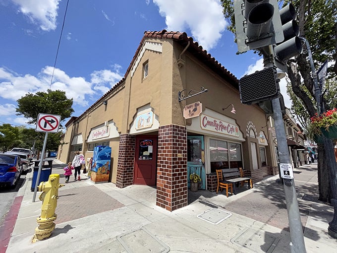 The corner spot that launched a thousand breakfast pilgrimages. Country Rose Café's Spanish-style exterior promises culinary treasures within.